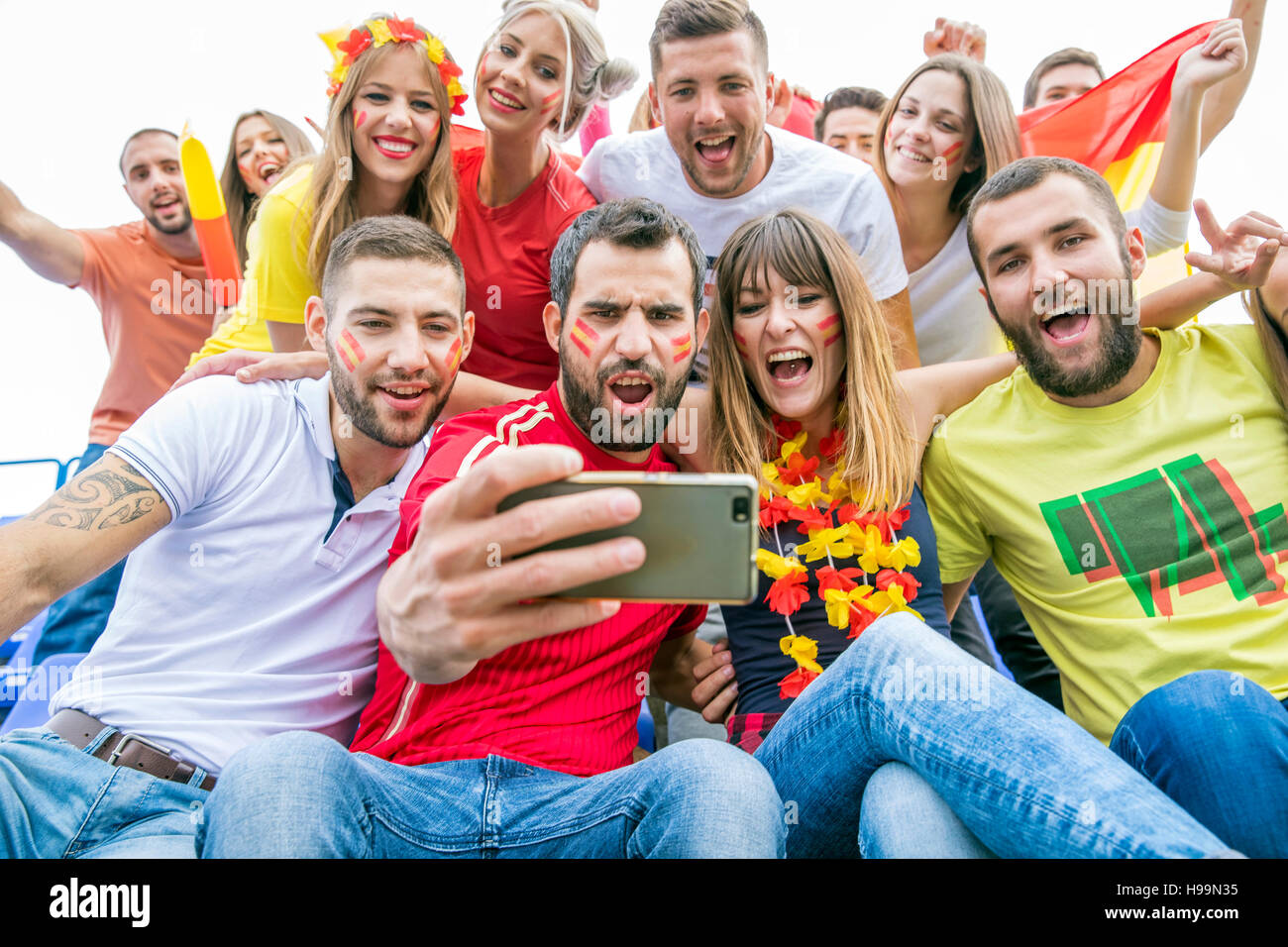 Group of soccer fans taking a selfie in stadium Stock Photo - Alamy