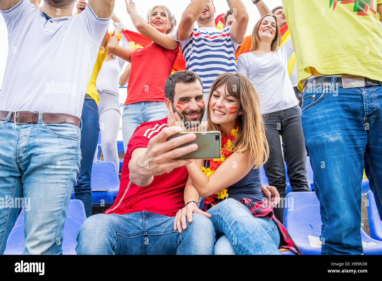 Soccer fans taking a selfie in stadium Stock Photo - Alamy