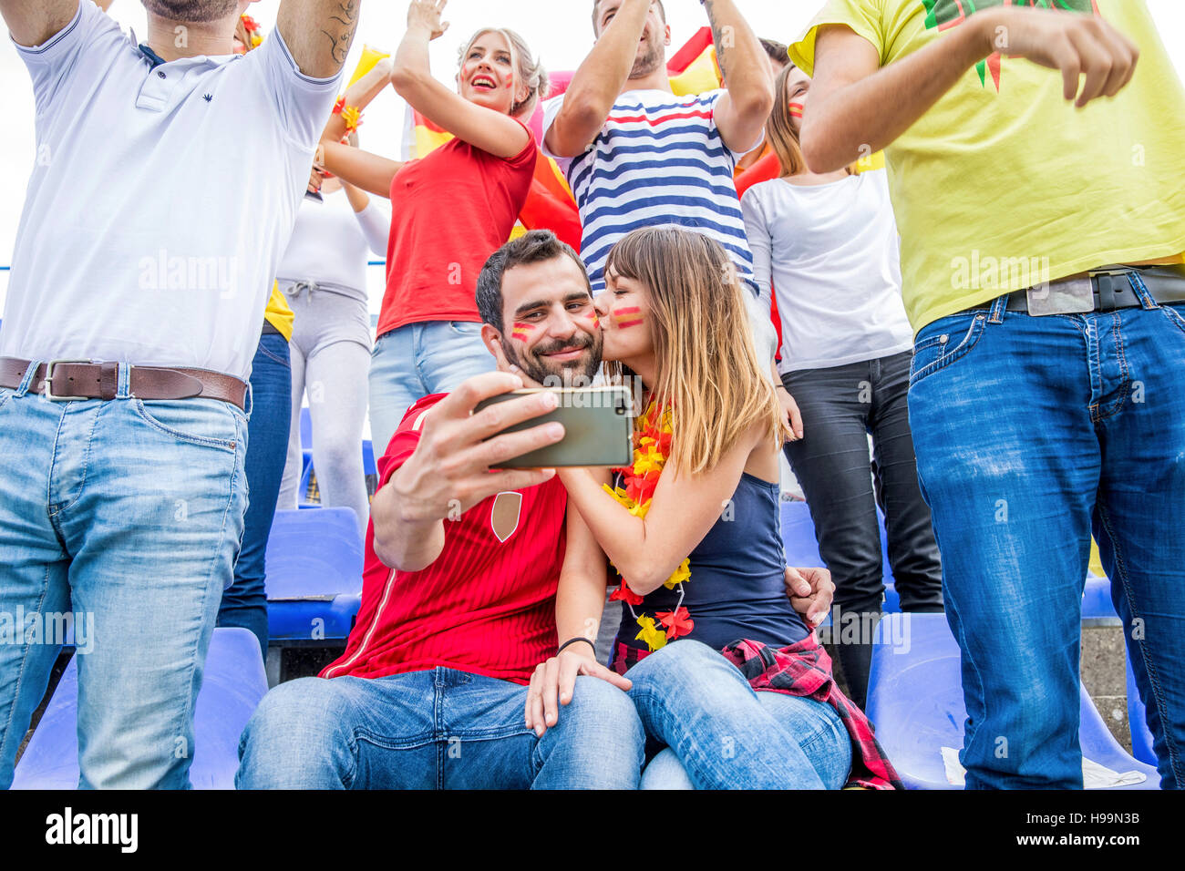 Soccer fans taking a selfie in stadium Stock Photo - Alamy