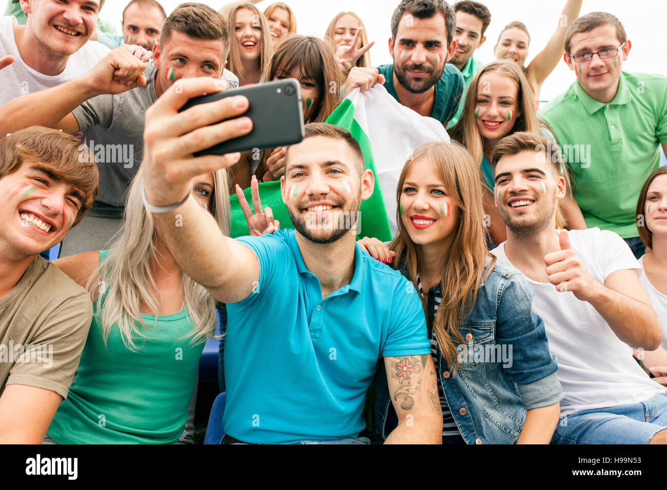 Group of fans in stadium taking a selfie Stock Photo - Alamy