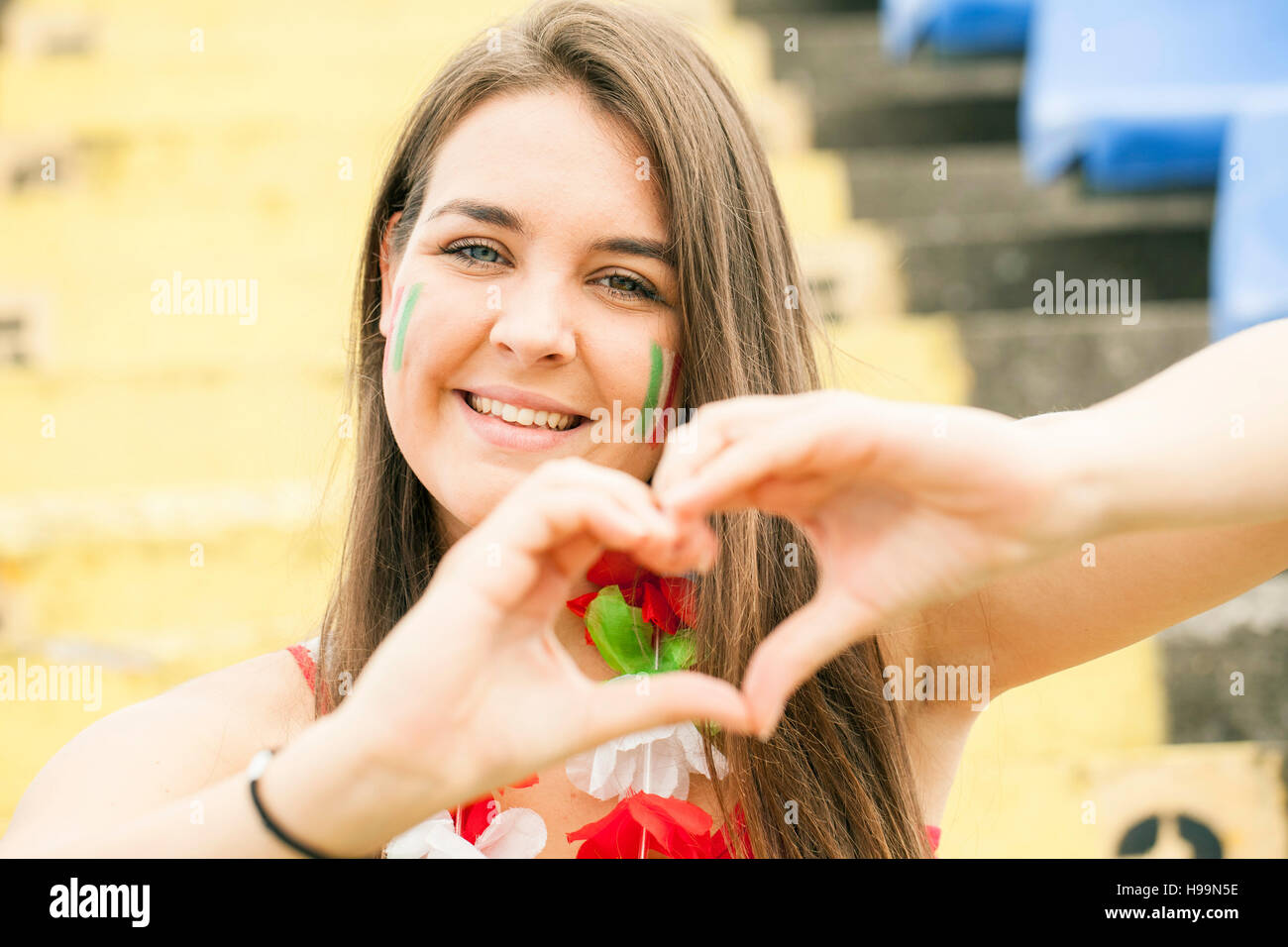 Female soccer fan forming heart with hands Stock Photo - Alamy