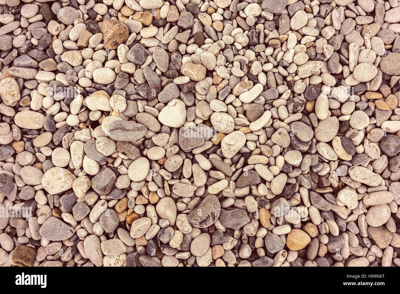 Different colored pebble stones for use as a background Stock Photo - Alamy