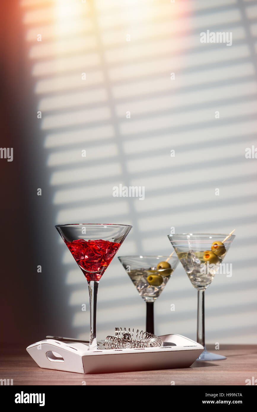 Three cocktails with strainer at the bar Stock Photo - Alamy
