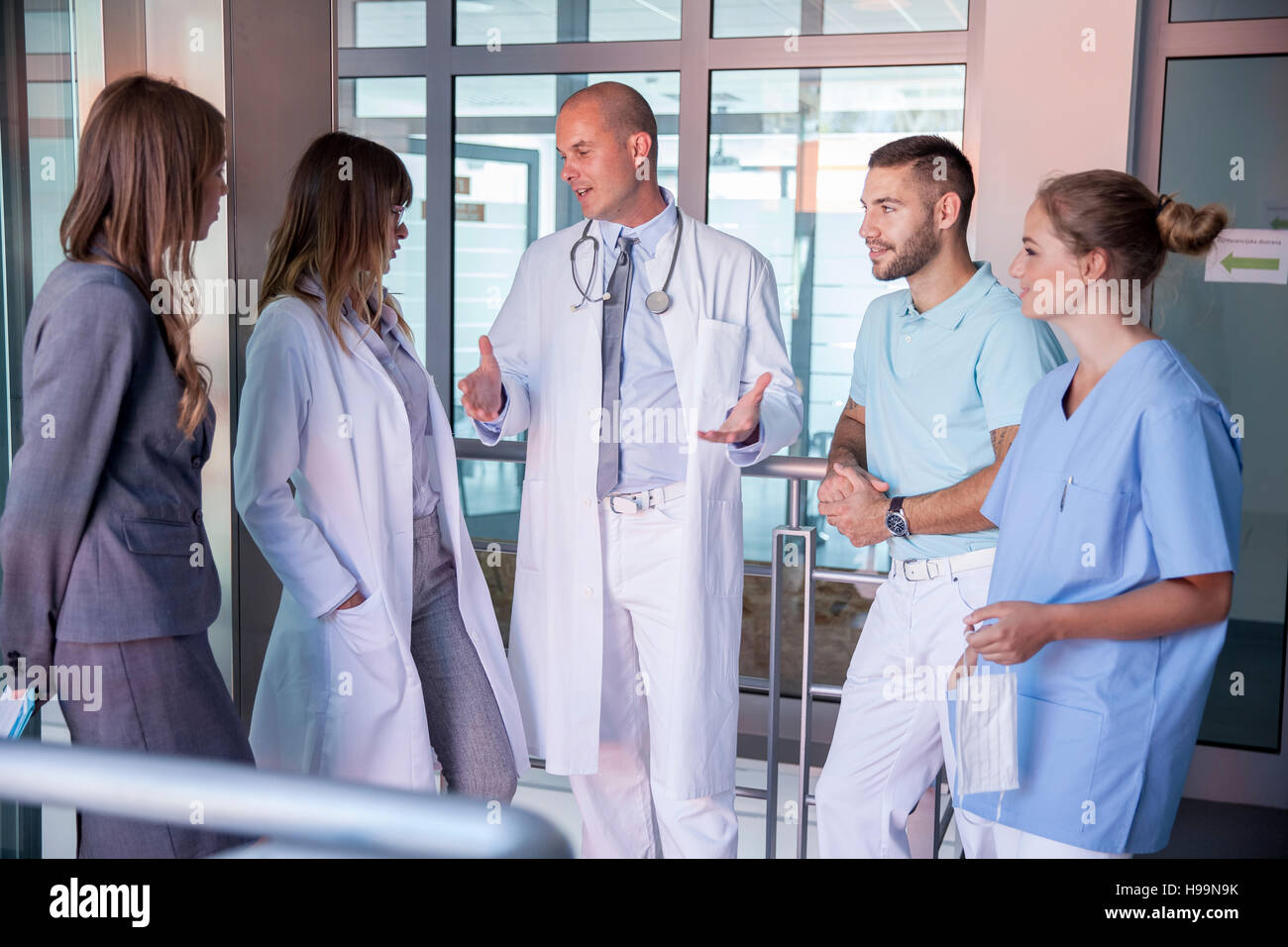 Doctor talking to his team in medical clinic Stock Photo - Alamy