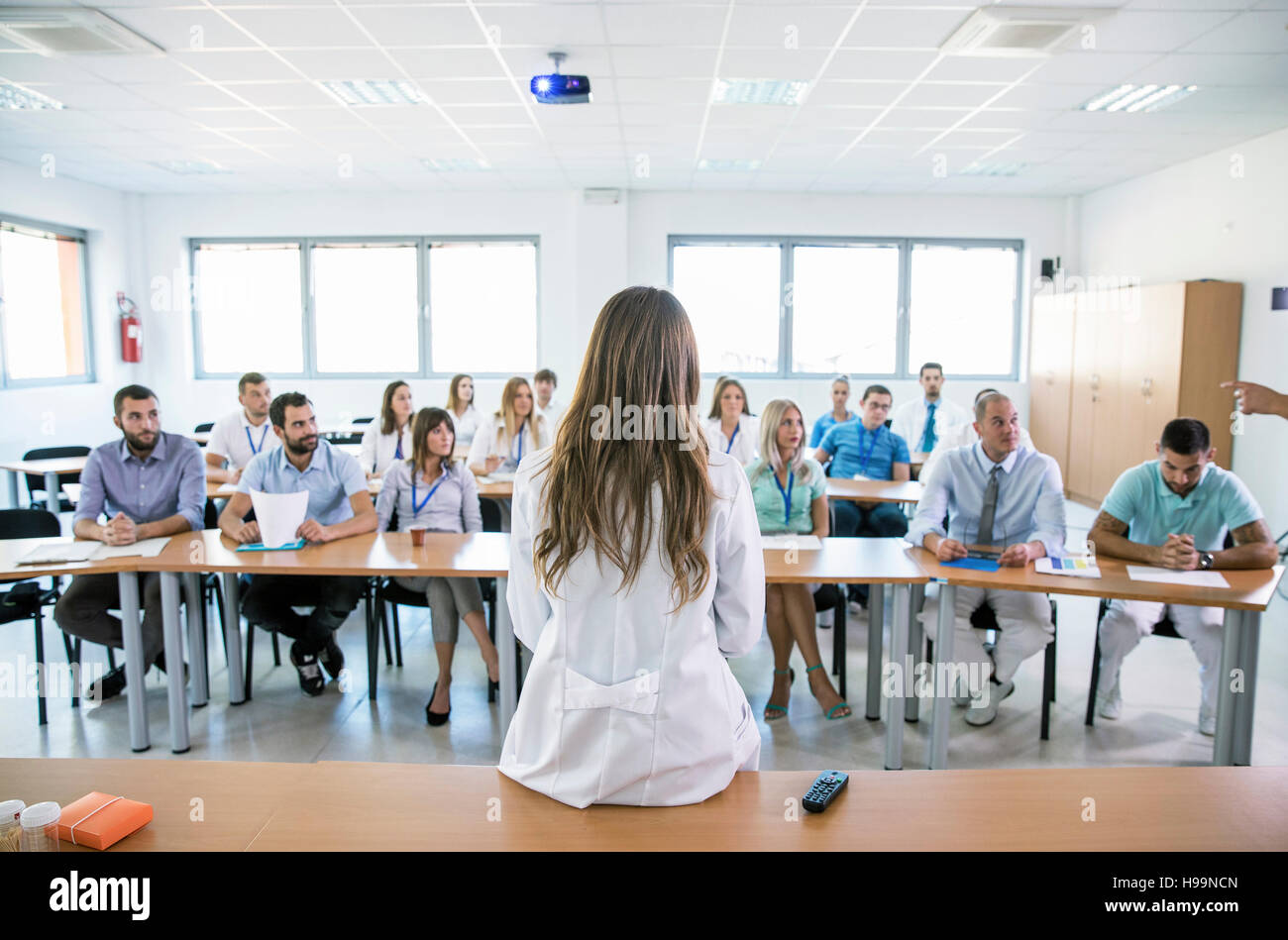 Female instructor teaching training class Stock Photo - Alamy