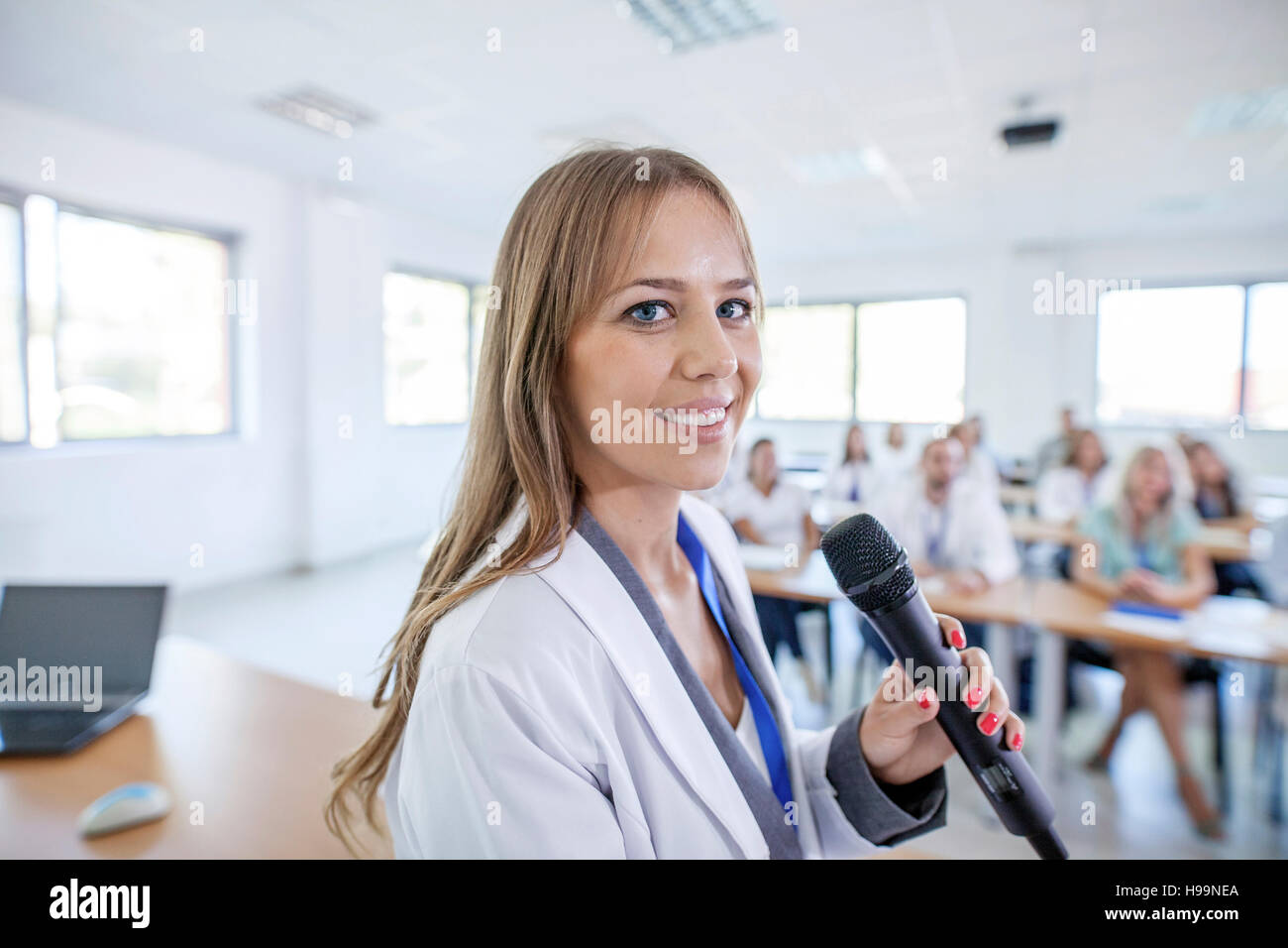 Female doctor giving presentation in training class Stock Photo - Alamy