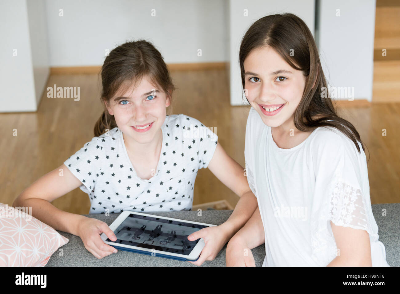 Teenage girls using digital tablet at home Stock Photo - Alamy