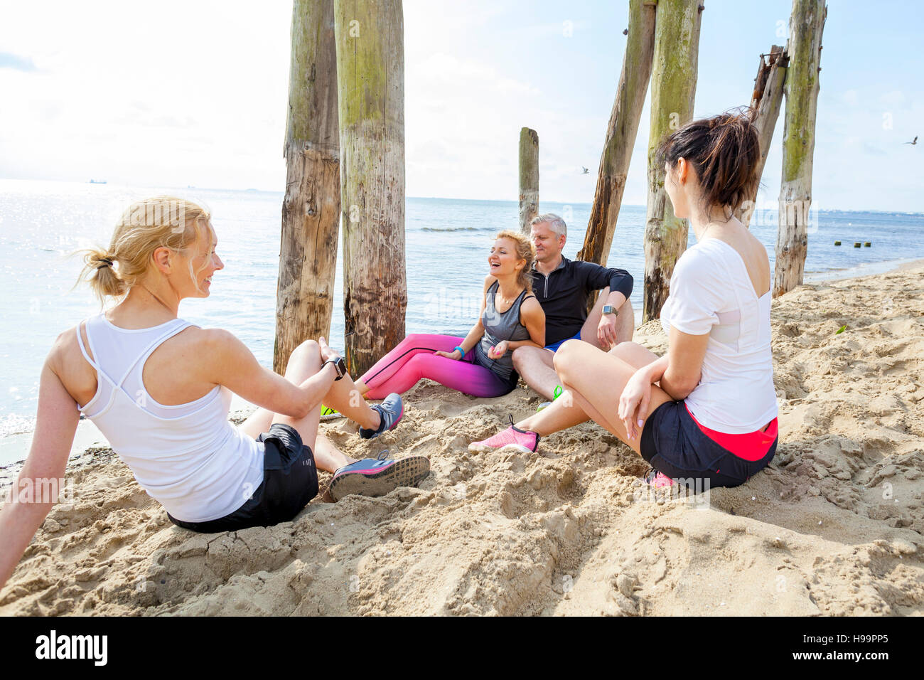 Group sitting on a beach hi-res stock photography and images - Alamy