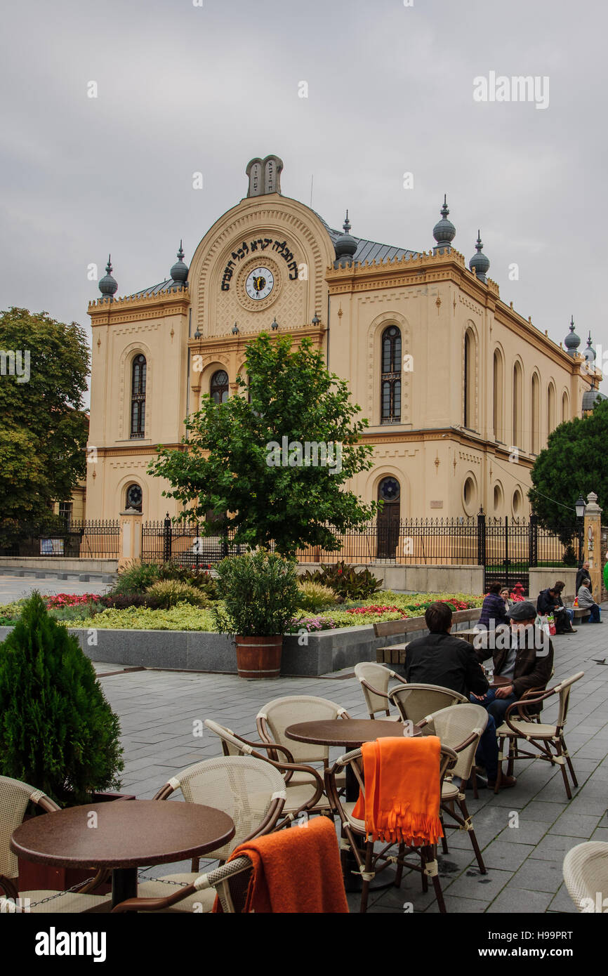 PECS, HUNGARY - SEP 28: People seating in cafe near the old synagogue ...