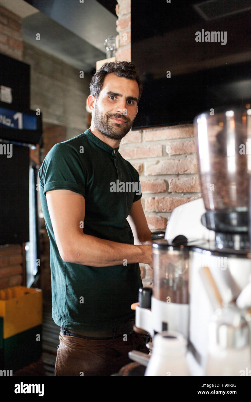 Bartender working at bar counter in coffee shop Stock Photo - Alamy