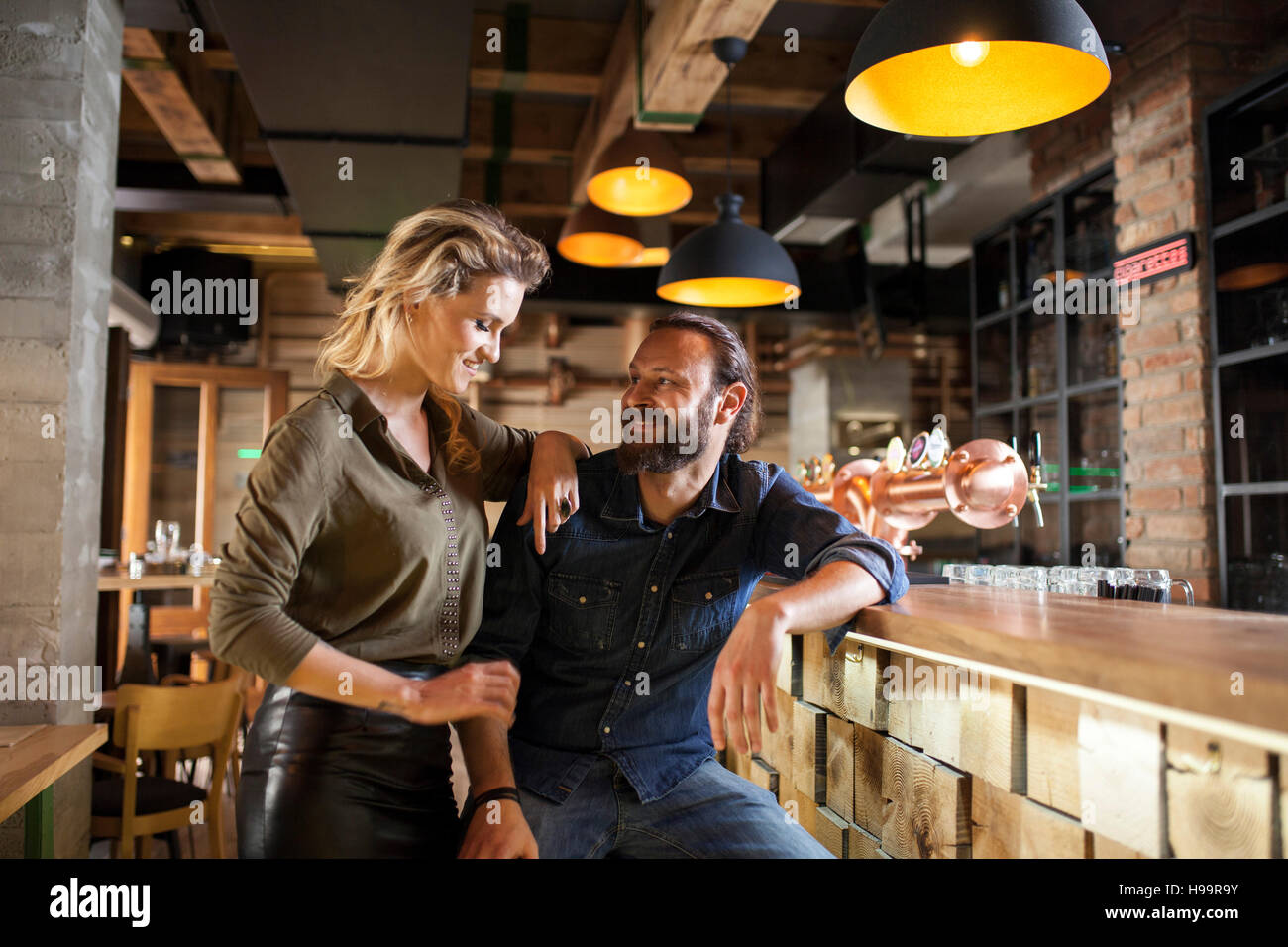 Portrait of couple at bar counter in coffee shop Stock Photo - Alamy