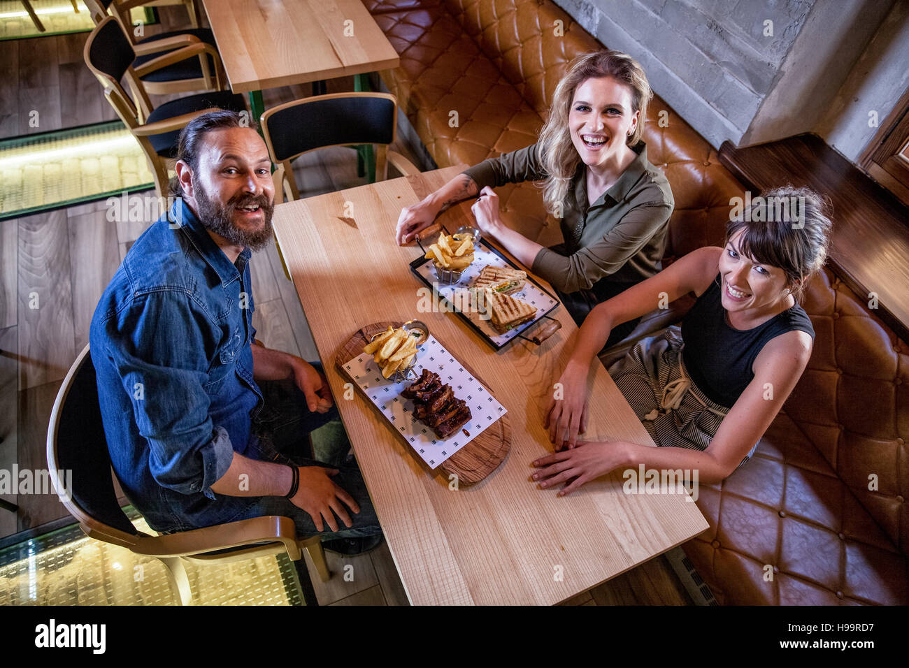 Laughing group of friends table hi-res stock photography and images - Alamy