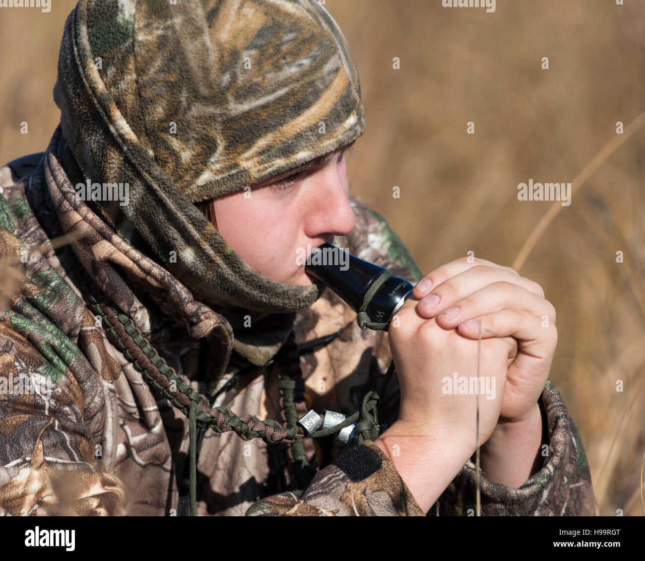 A young hunter blowing a duck and goose call Stock Photo - Alamy