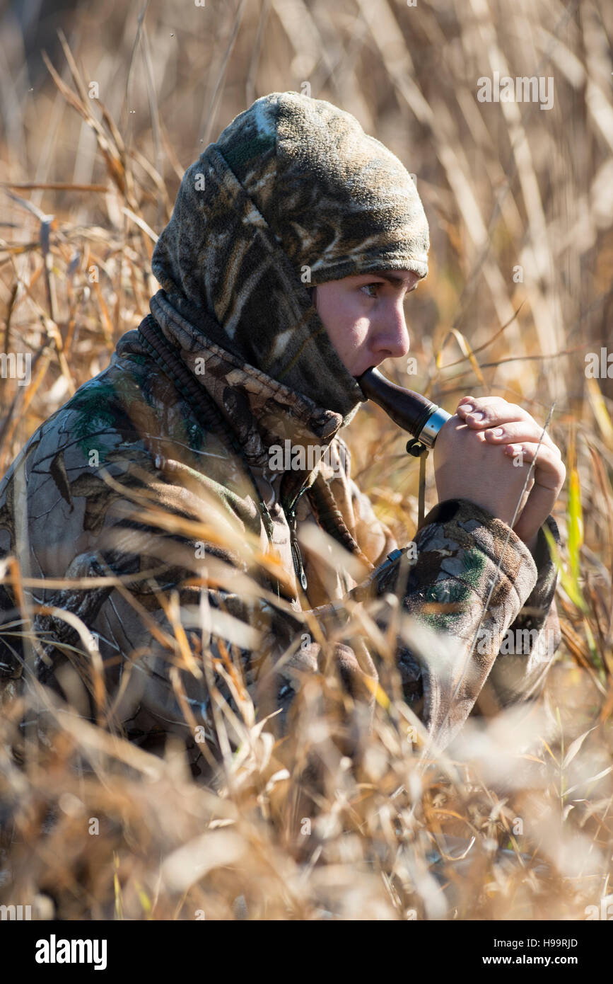 A young hunter blowing a duck and goose call Stock Photo - Alamy