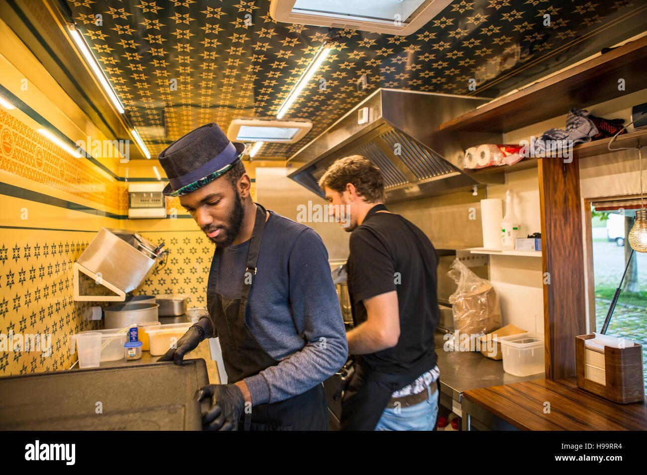 Two men cooking in commercial kitchen of food truck Stock Photo - Alamy