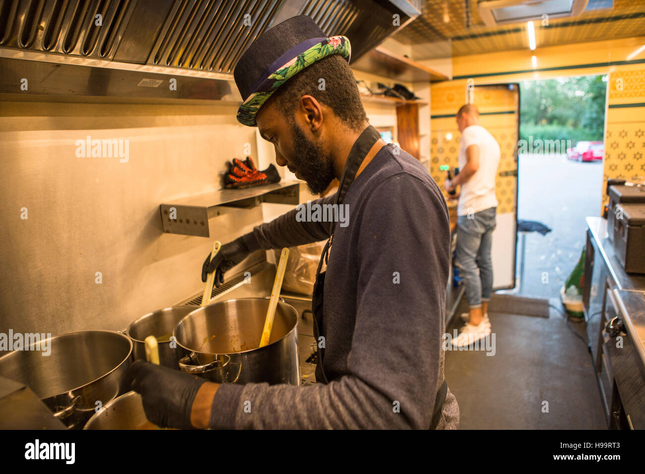 Two men cooking in commercial kitchen of food truck Stock Photo - Alamy