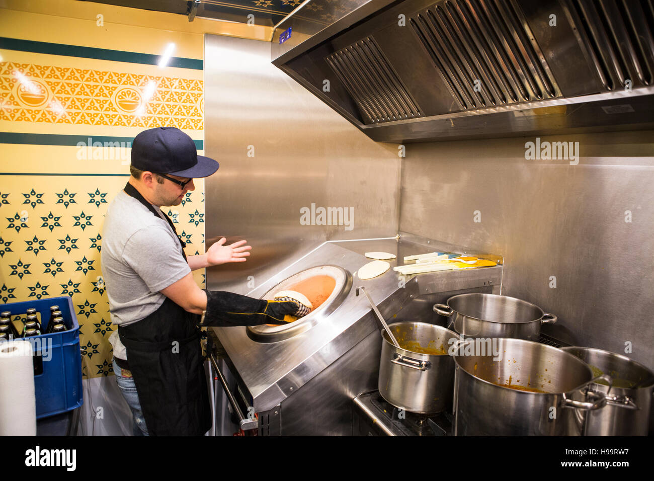 Man cooking in commercial kitchen of food truck Stock Photo - Alamy