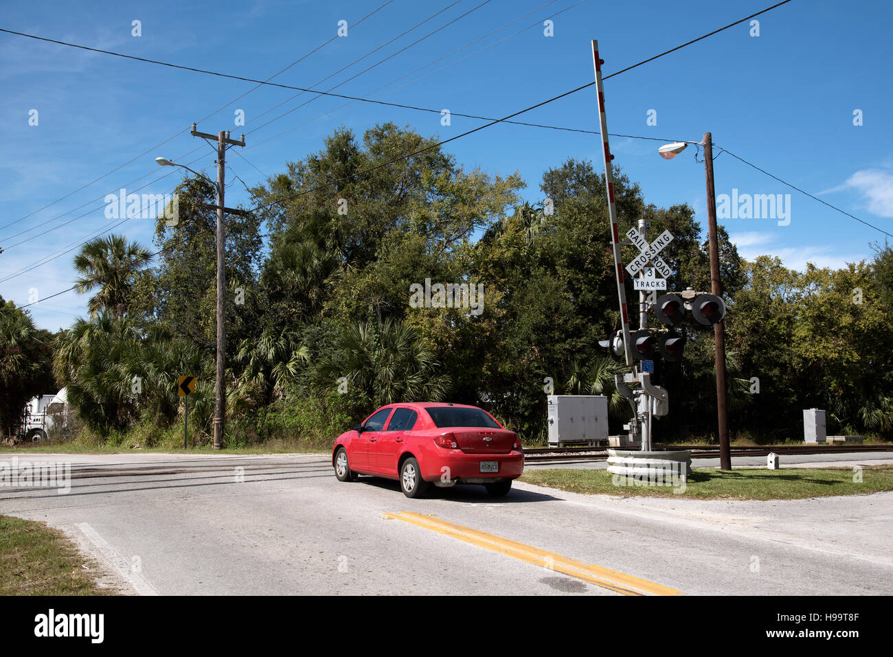 DeLand Florida USA - A red car driving over the railroad tracks at ...