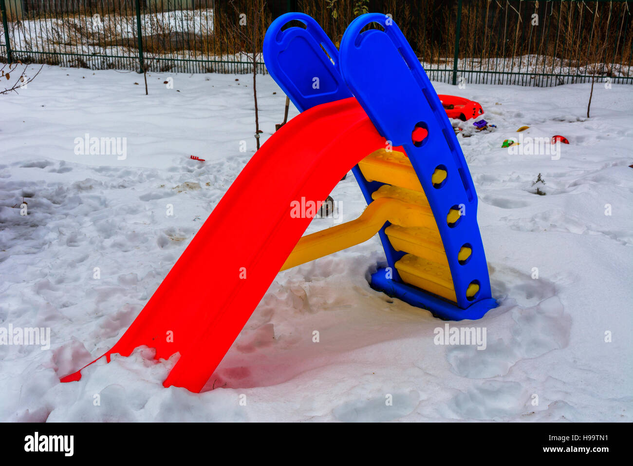 Children's toys covered with snow in the yard of a private house Stock ...
