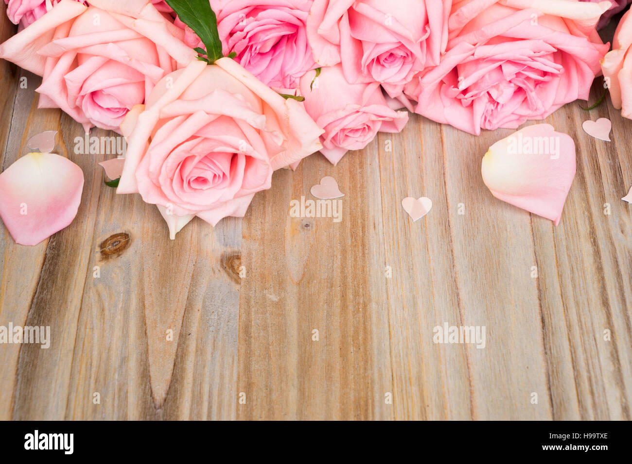 Pink blooming roses on wood Stock Photo - Alamy