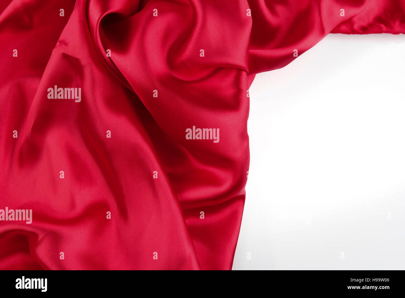 Closeup of folds in red silk fabric on plain background Stock Photo - Alamy