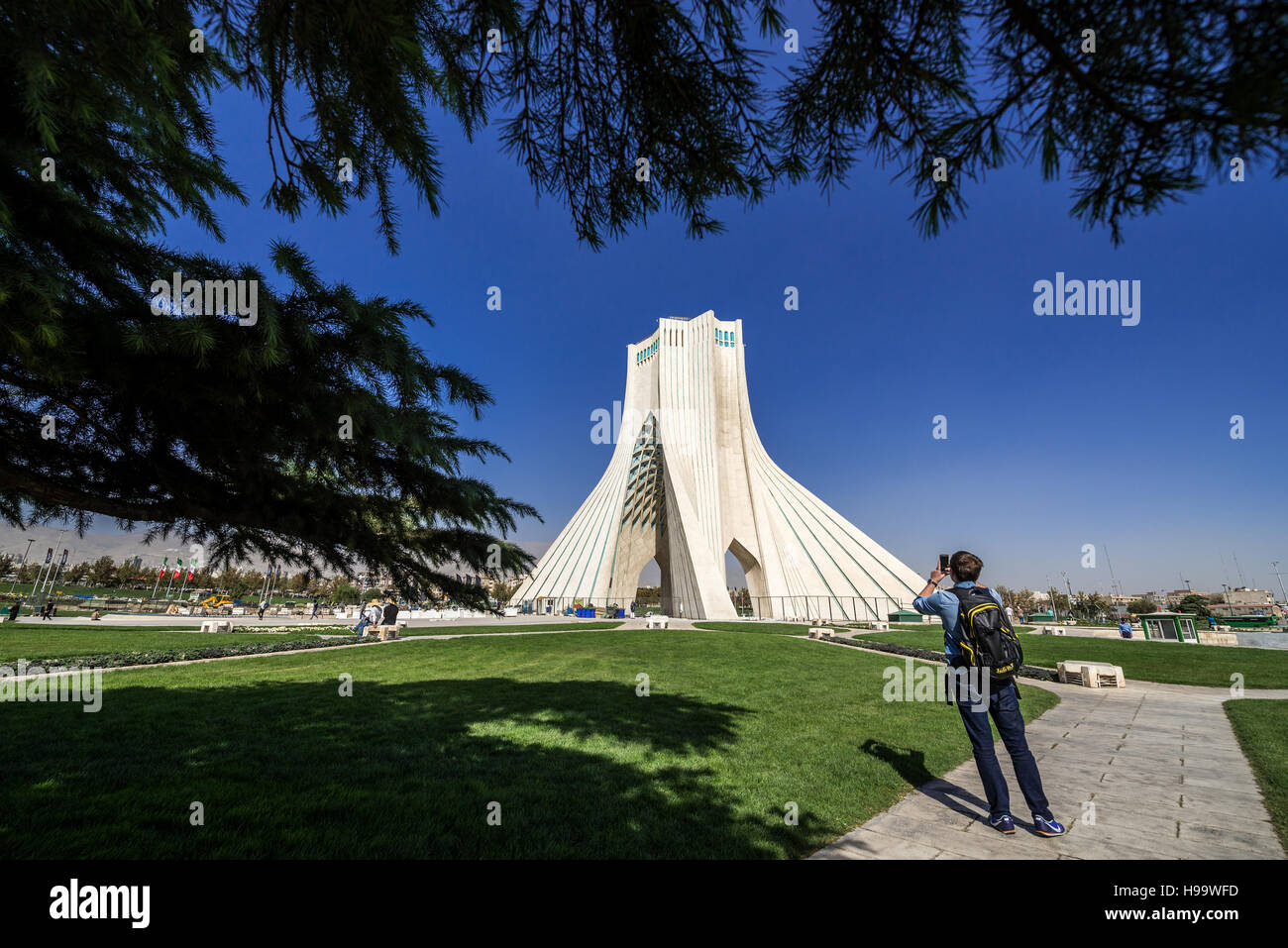 Tourist takes photo of Azadi Tower, formerly known as the Shahyad Tower ...