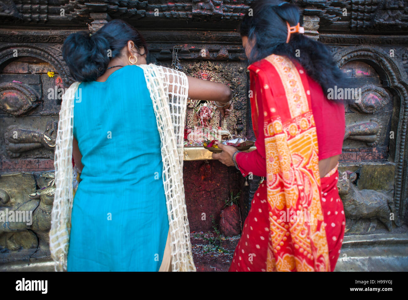 Women offering to the gods at a shrine near World Heritage listed ...