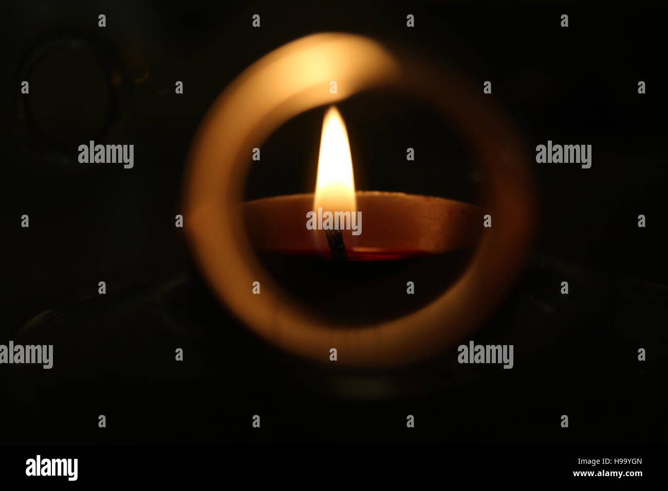 Candlelight through a circle of reflection Stock Photo - Alamy