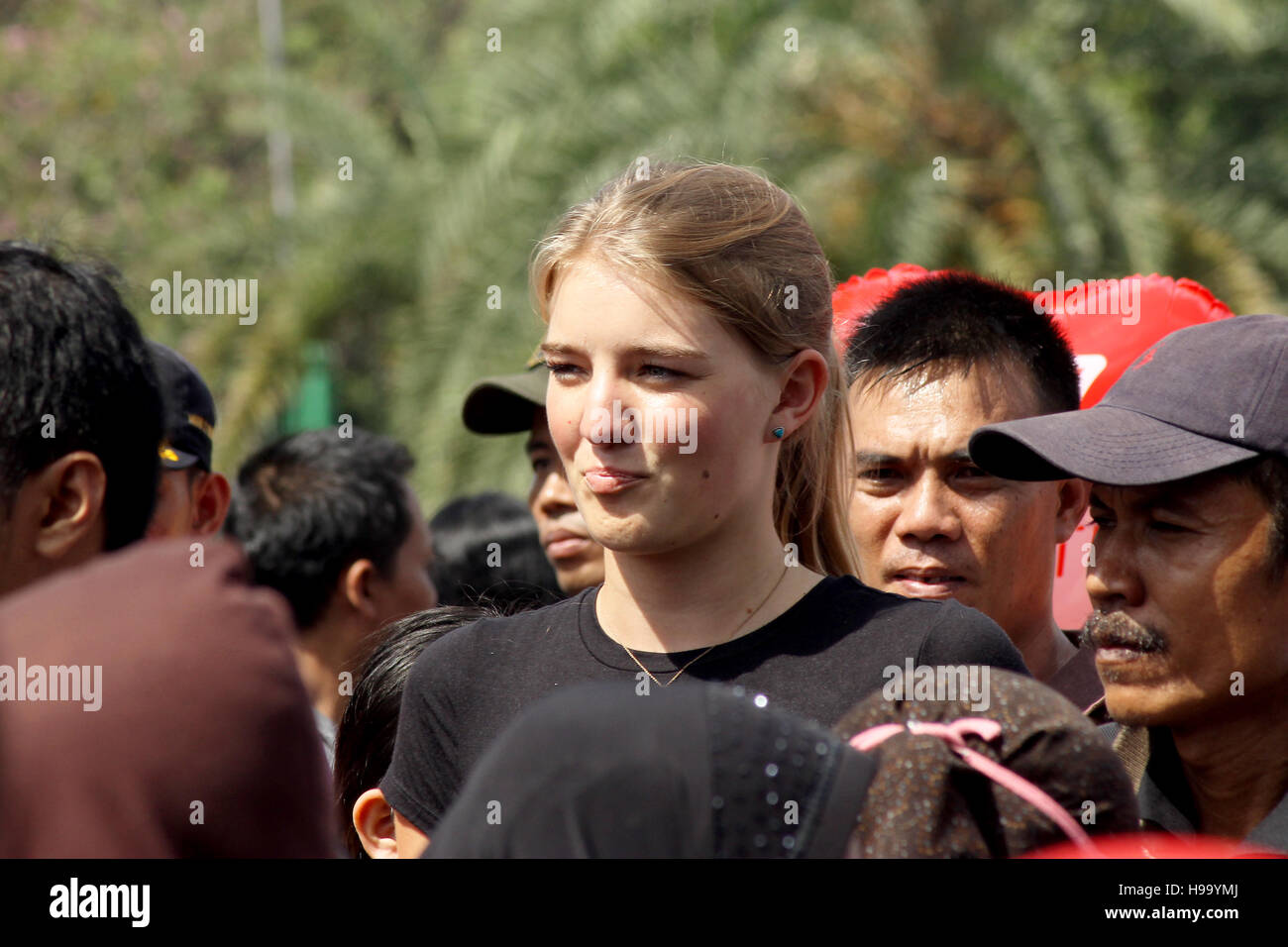 Beautiful woman in the middle of crowd of people who following the ...