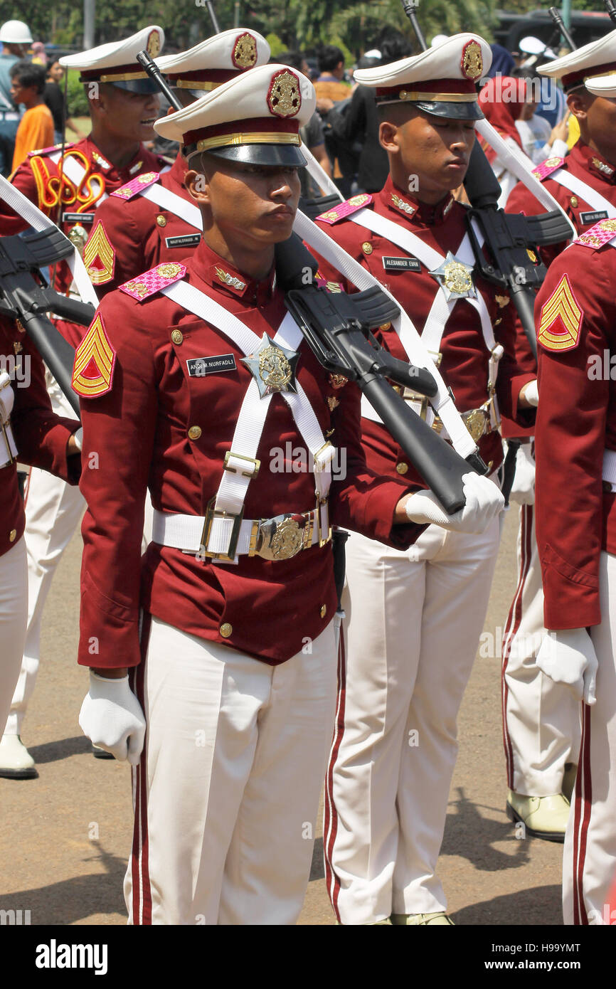 Indonesian police cadets marching with rifle in independence day flag ...