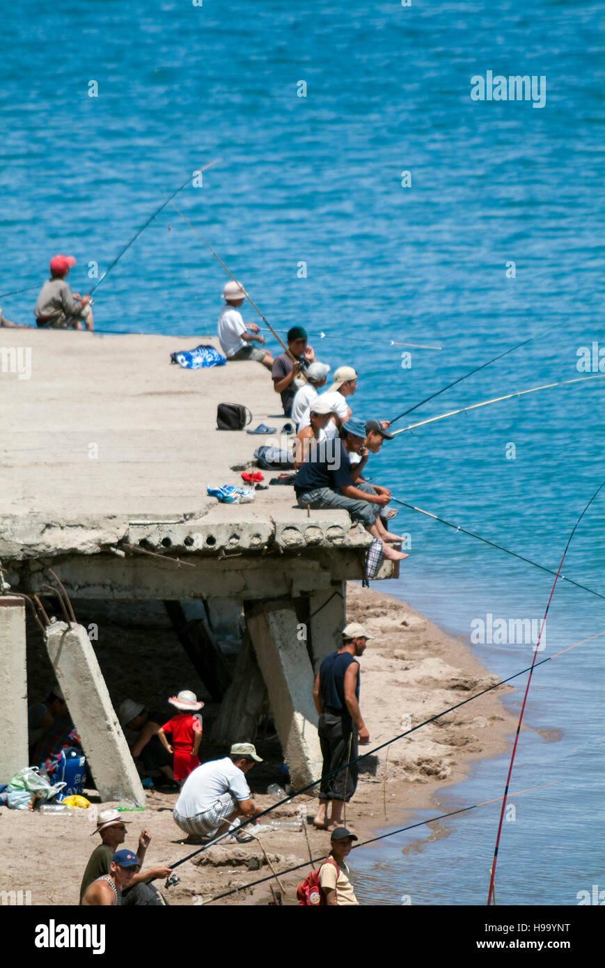 People fishing on the shore of Lake Issyk Kul Stock Photo - Alamy