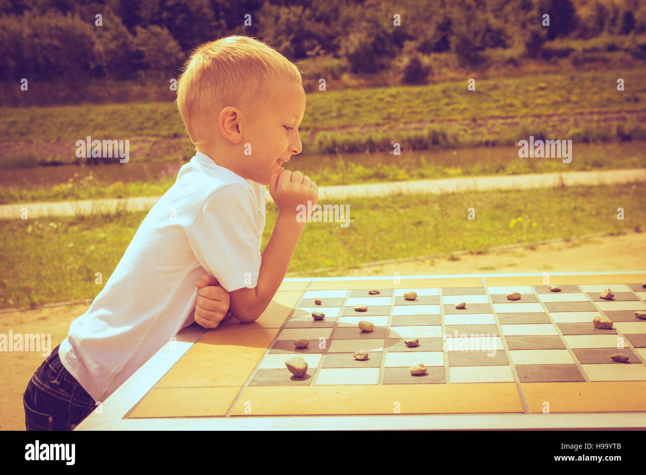 Draughts board game. Little boy clever child kid playing checkers ...