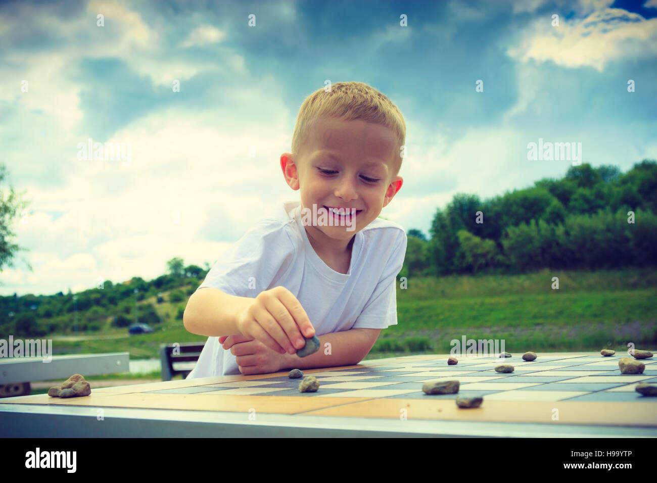 Draughts board game. Little boy clever child kid playing checkers ...