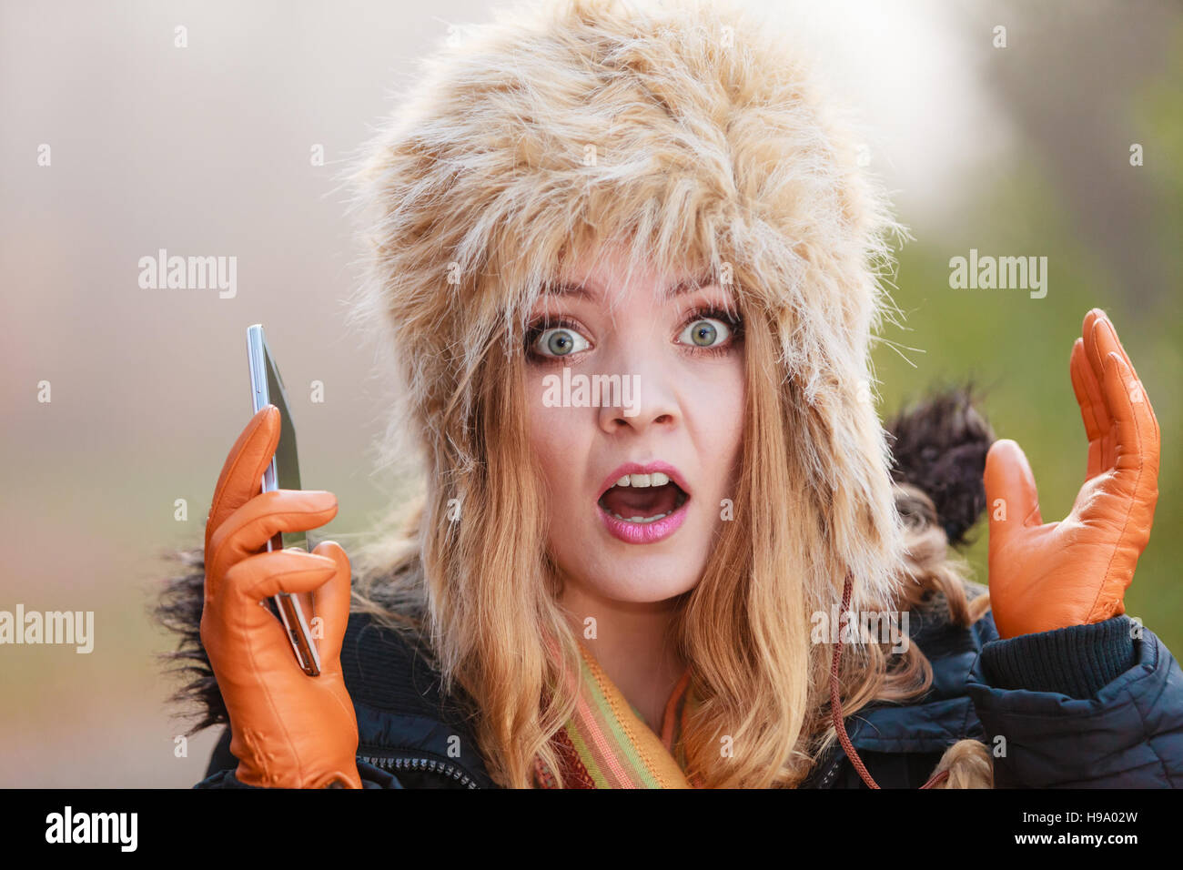 Portrait of scared afraid pretty woman talking on mobile phone ...