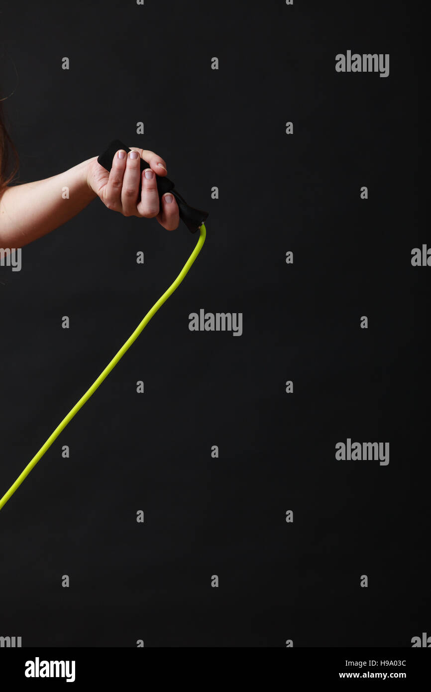 Woman spend actively free time. Female hand with jumping skipping rope ...