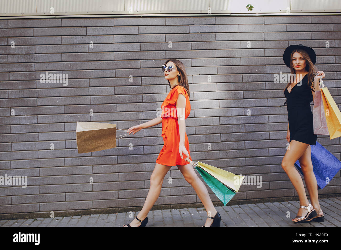 two beautiful young women walk to the shops and make purchases Stock ...
