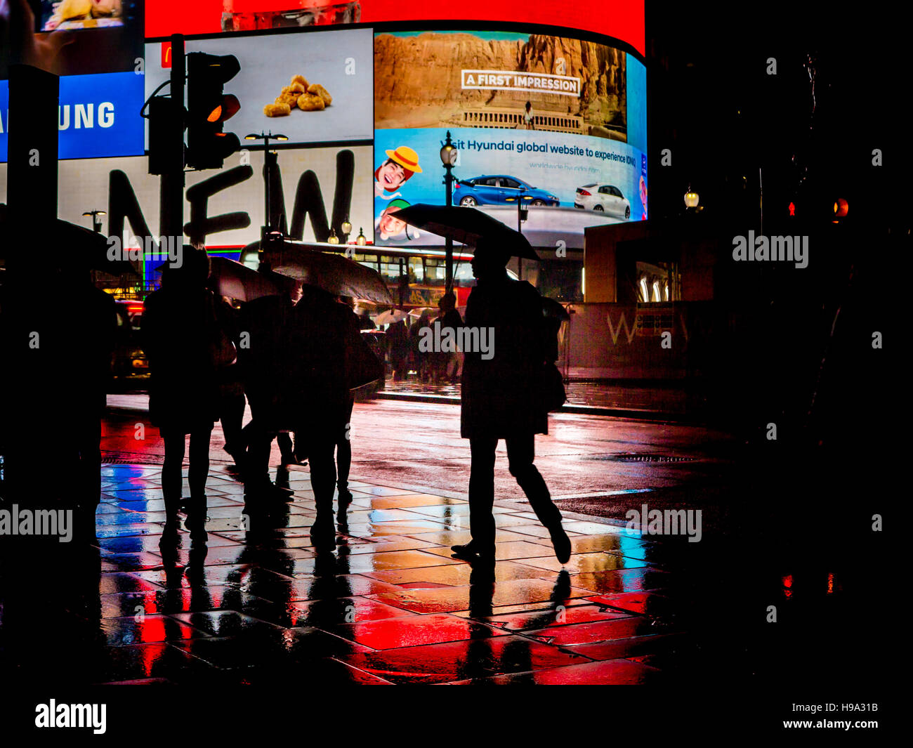 Rain reflects Piccadilly Circus lights in Central London Stock Photo ...