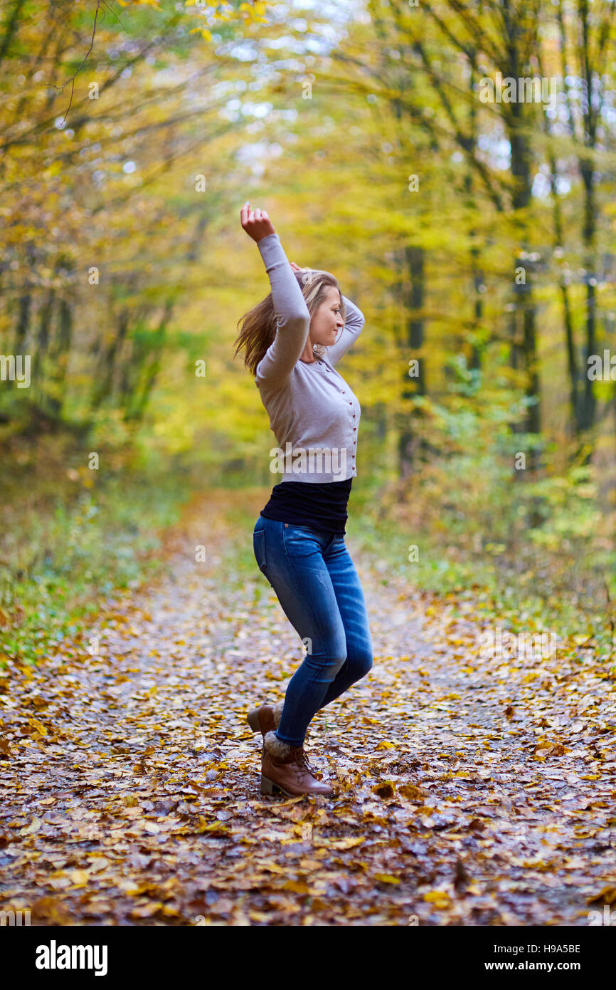 Young woman casual dressed dancing in the forest Stock Photo - Alamy