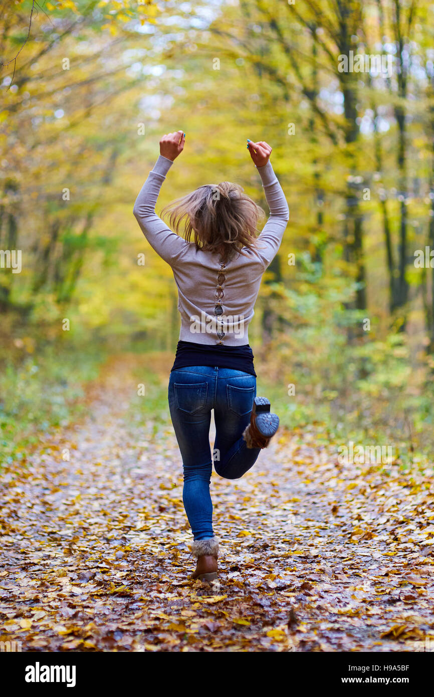 Young woman casual dressed dancing in the forest Stock Photo - Alamy