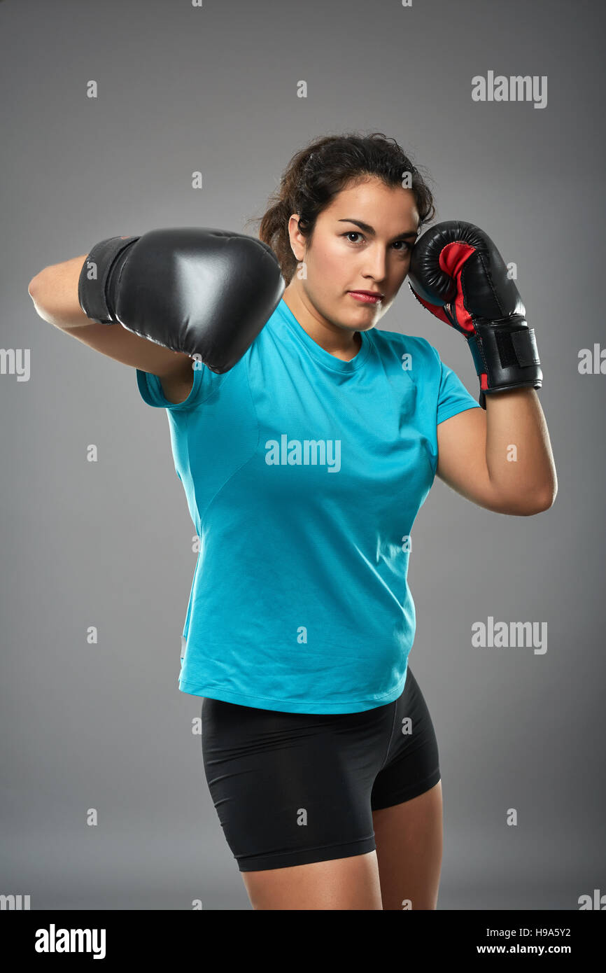 Strong hispanic female kickbox fighter delivering a hook Stock Photo ...