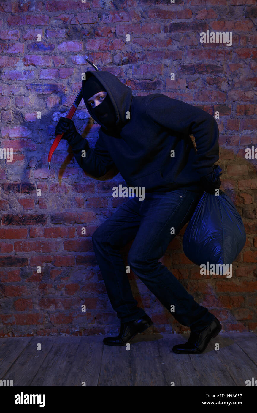 Thief with bag and pickaxe Stock Photo - Alamy