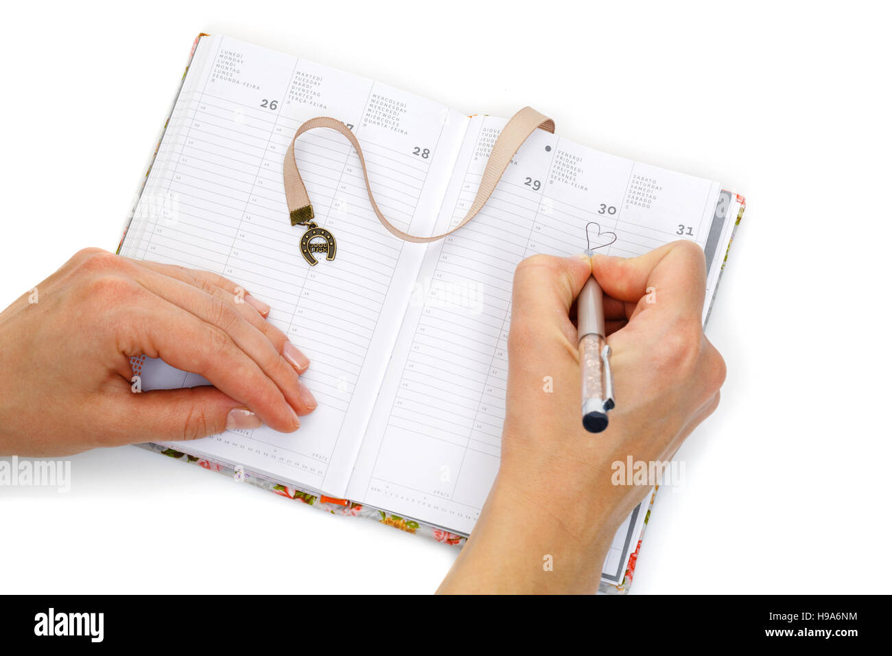 Notebook opened with female hands writing Stock Photo - Alamy