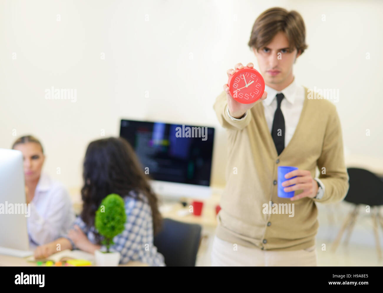 young angry businessman pointing his watch as concept of arrive late at ...