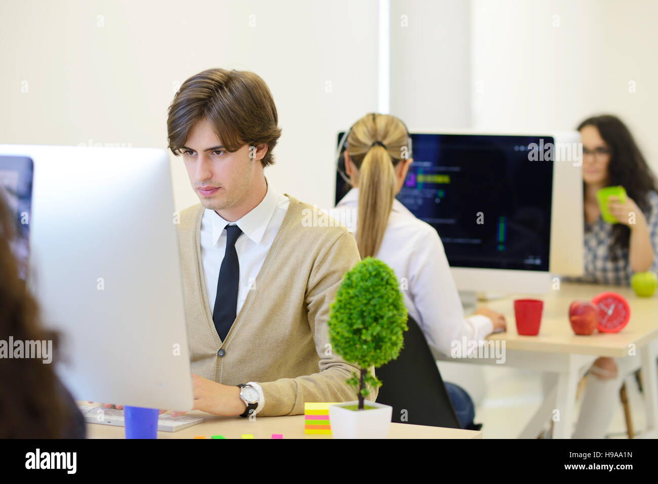 startup business, software developer with braces working on computer at ...