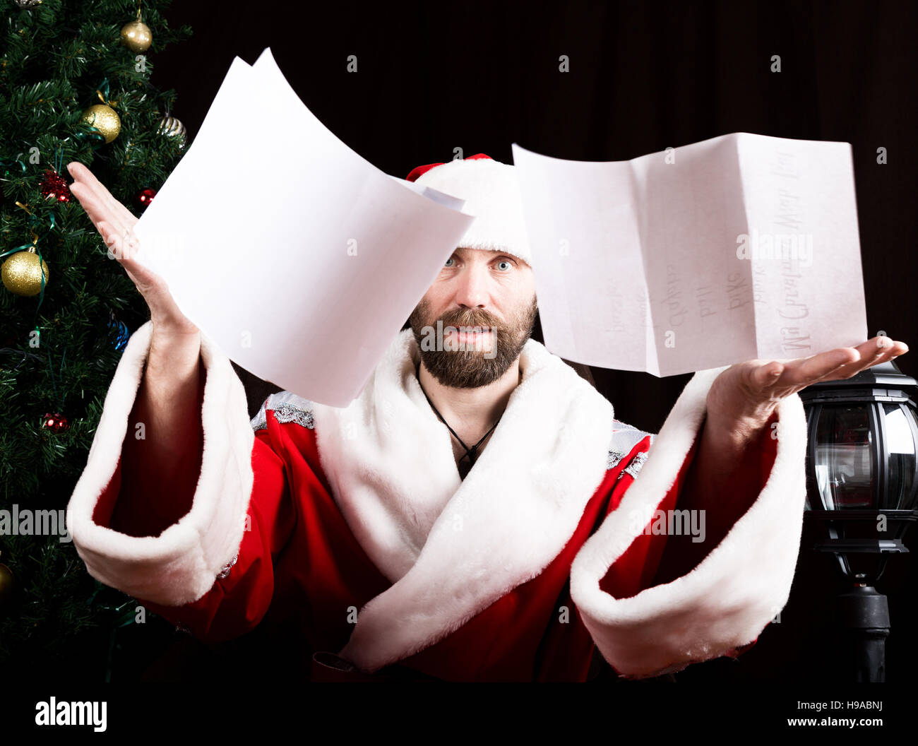 bad brutal Santa Claus discontentedly reads letter with the wishes and ...
