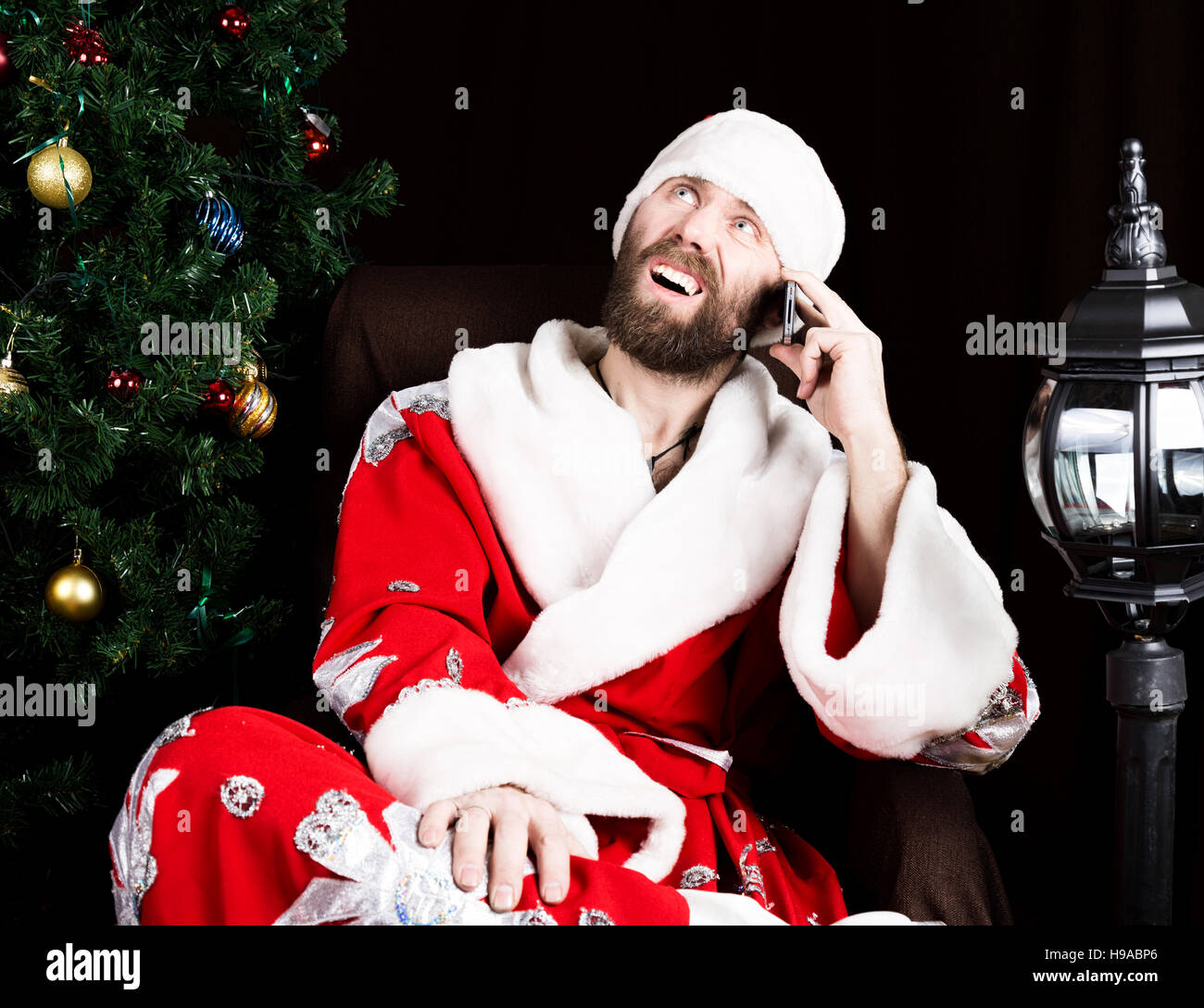 bad brutal Santa Claus holding the bag with gifts and dissatisfied ...