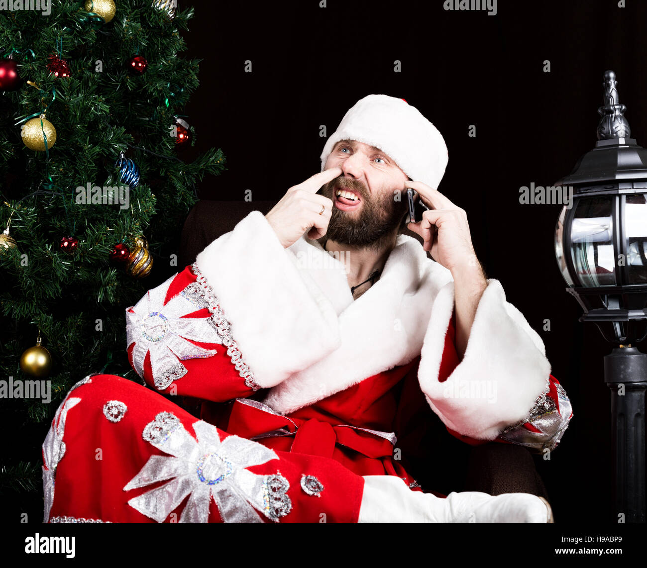 bad brutal Santa Claus dissatisfied talking phone and picking his nose ...