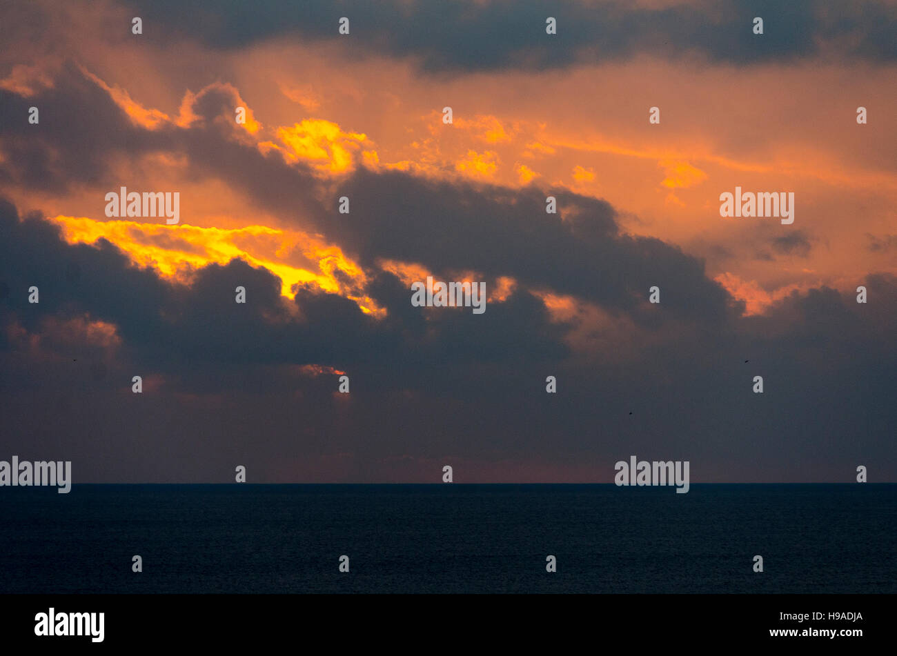 Late afternoon sun behind clouds, Anaiki, Niue, South Pacific, Oceania ...