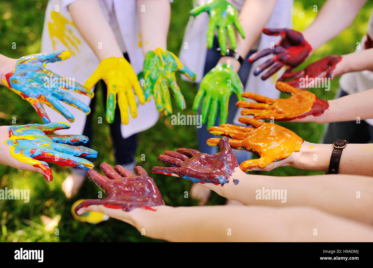 lots of hands in the paint in a circle Stock Photo - Alamy