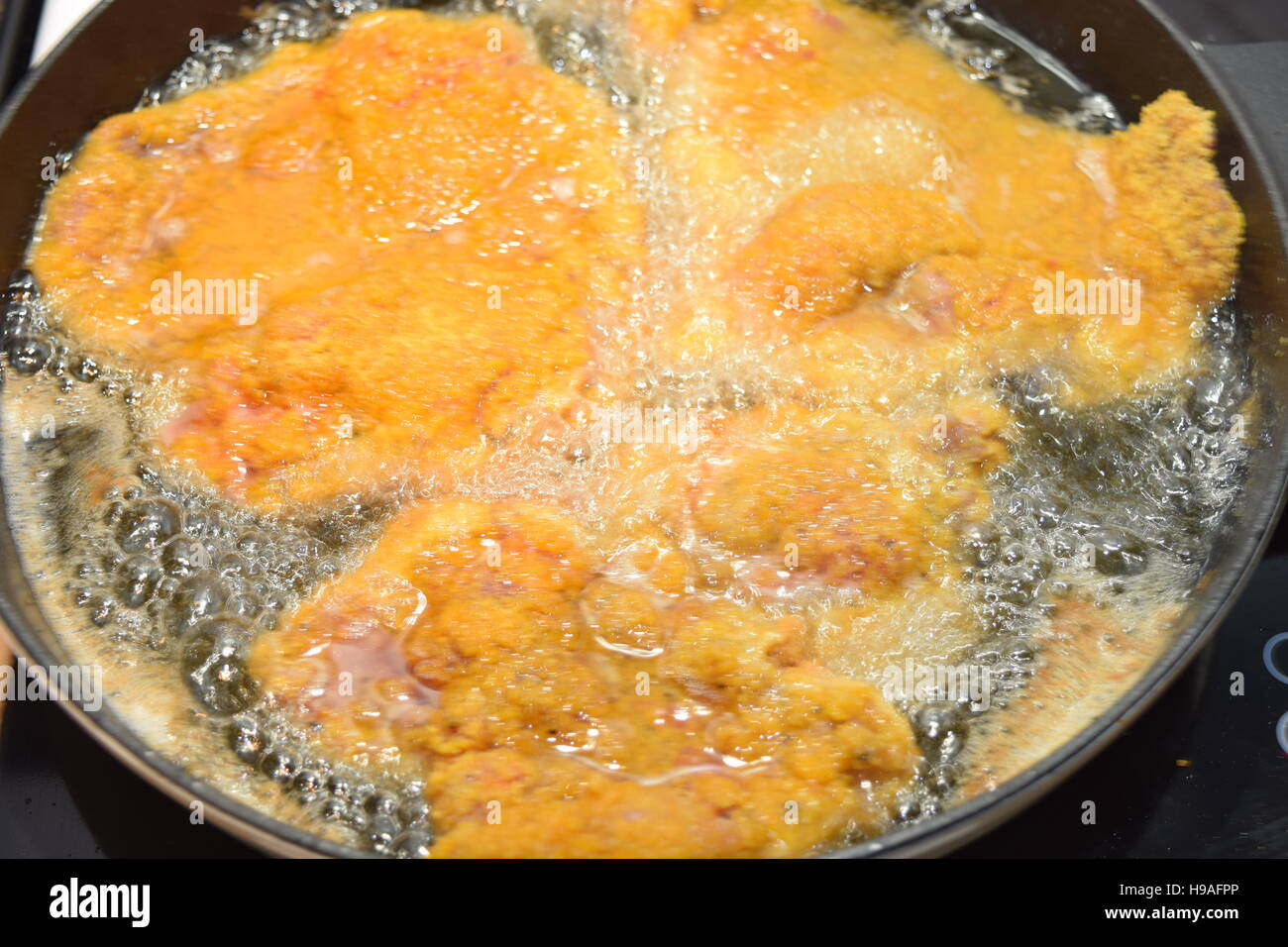 Close-up of wiener schnitzel frying with a bright light shining Stock ...